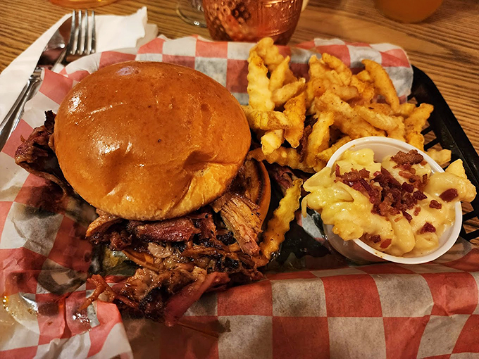 Behold, the pulled pork sandwich in all its glory! Tender, smoky meat nestled in a soft bun, with crispy fries standing guard.