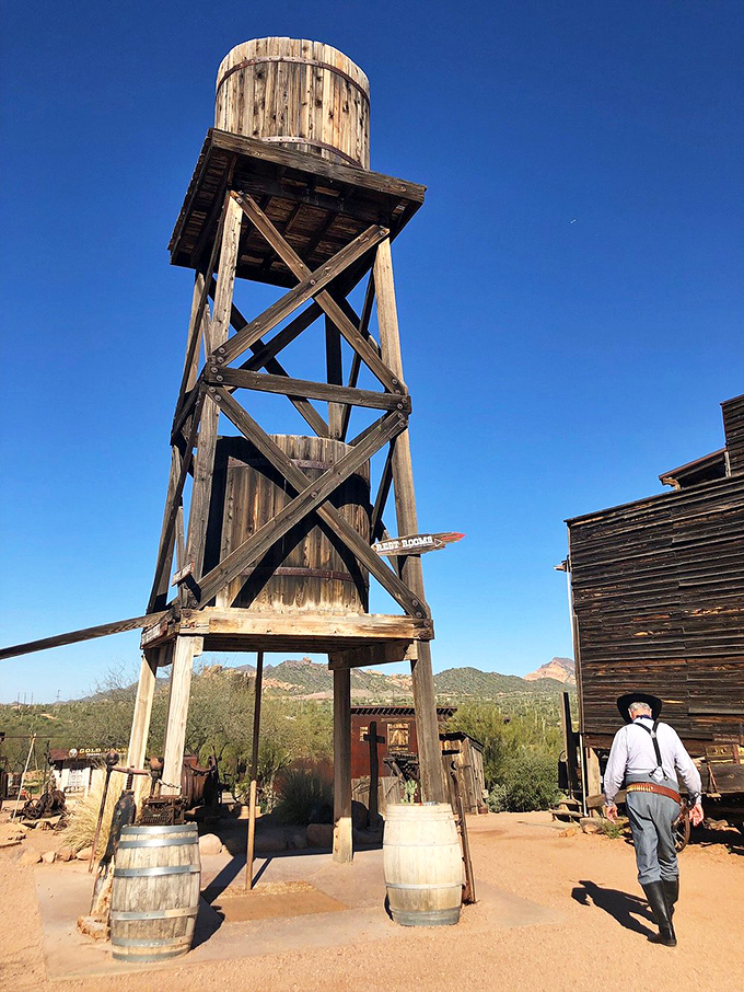 The town's wooden water tower stands tall against the brilliant blue Arizona sky, a testament to frontier engineering.
