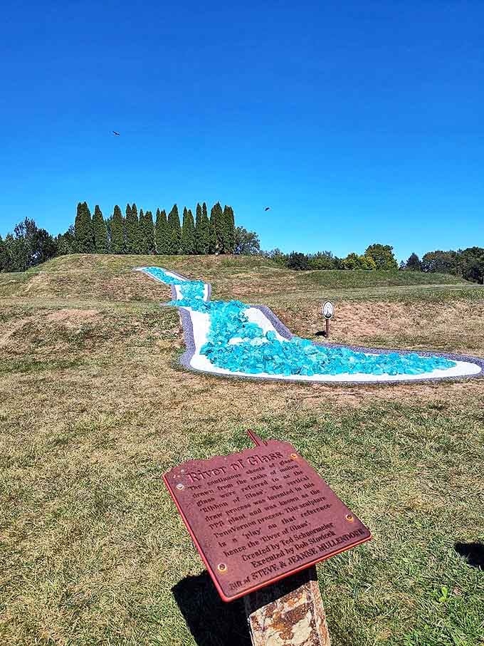 The River of Glass cascades down the hillside like a frozen blue waterfall, telling the story of innovation through its vibrant azure chunks.