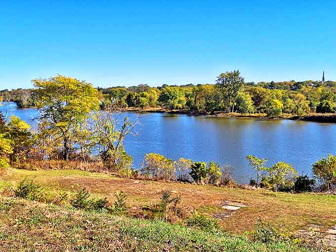 The Maumee River curves gently past autumn trees, the same timeless view that settlers gazed upon while building their new lives.