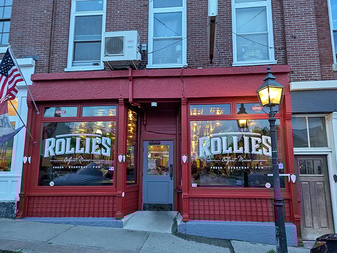 Rollie's Bar & Grill glows invitingly at dusk, promising cold drinks, hearty food, and the kind of local conversation you'll remember long after leaving.