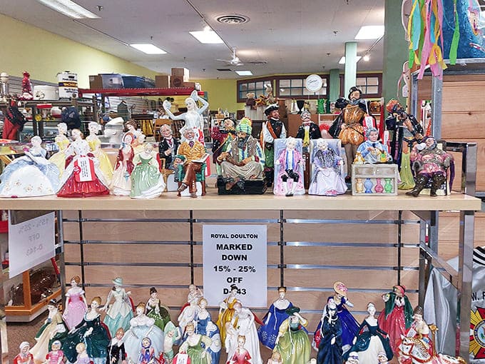 Royal Doulton figurines stand in elegant formation, their hand-painted finery and porcelain poise a testament to craftsmanship rarely seen today.