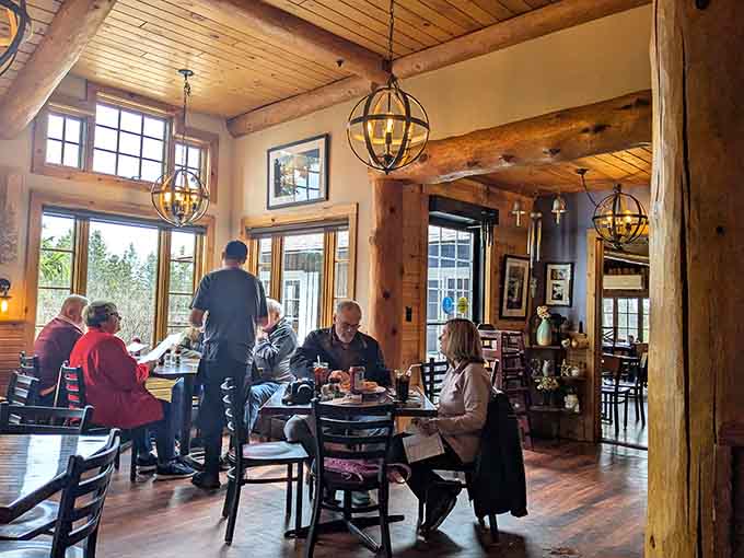 Happy diners enjoying their meals in a space that feels like someone's really nice lake house opened for business.