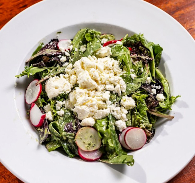 Even the salads deserve attention, with fresh greens, crisp radishes, and crumbled cheese offering a lighter counterpoint to the heartier fare.