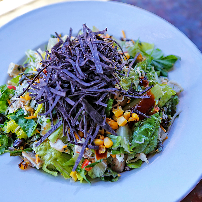 A mountain of crisp greens crowned with tortilla strips - proving salads don't have to be boring.