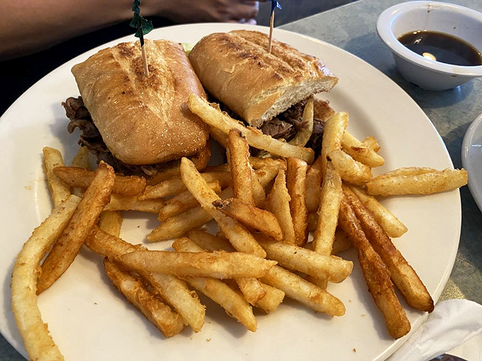 Sandwich perfection: piled high, served with crispy fries, and requiring a stack of napkins. It's messy, delicious, and worth every bite.
