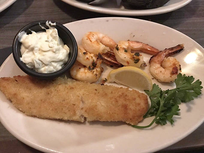 The surf-and-turf dream team: saut&eacute;ed walleye and broiled shrimp sharing a plate like old friends. That parsley garnish isn't just pretty&mdash;it's the perfect bright note to finish.