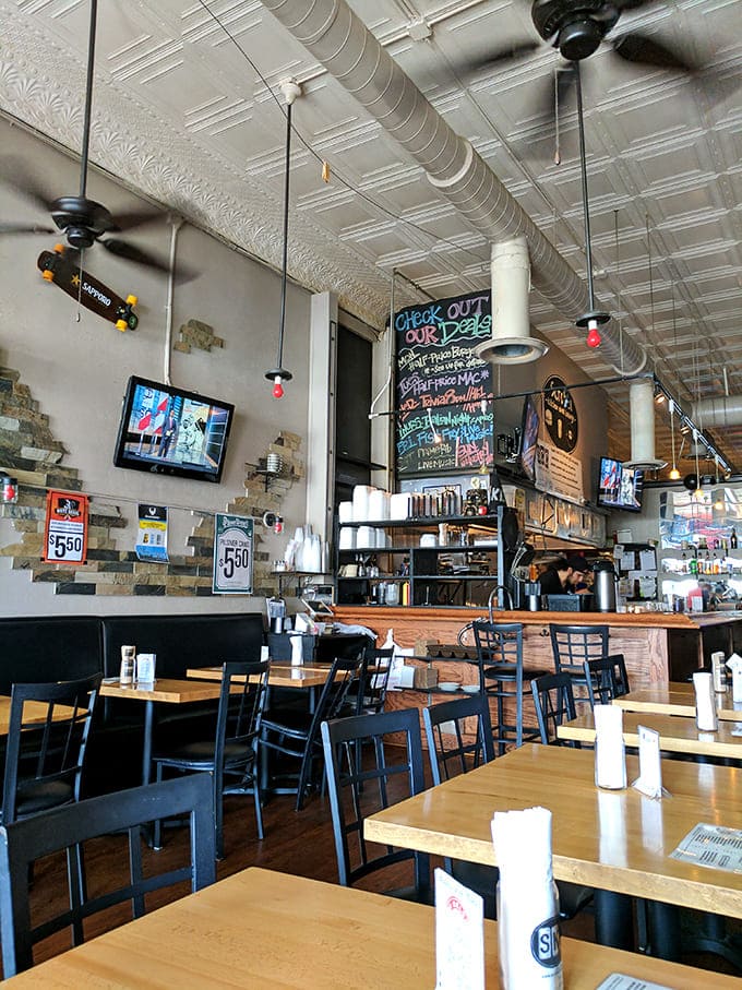 The dining area balances casual comfort with just enough style, featuring wooden tables and quirky decor that gives the space personality without trying too hard.