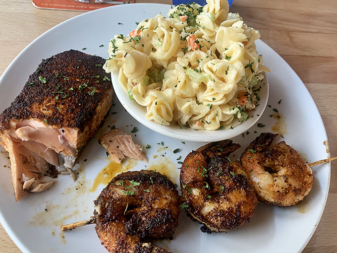 Blackened salmon and grilled shrimp sharing a plate with creamy pasta salad. The seafood equivalent of bringing your A-team to dinner.