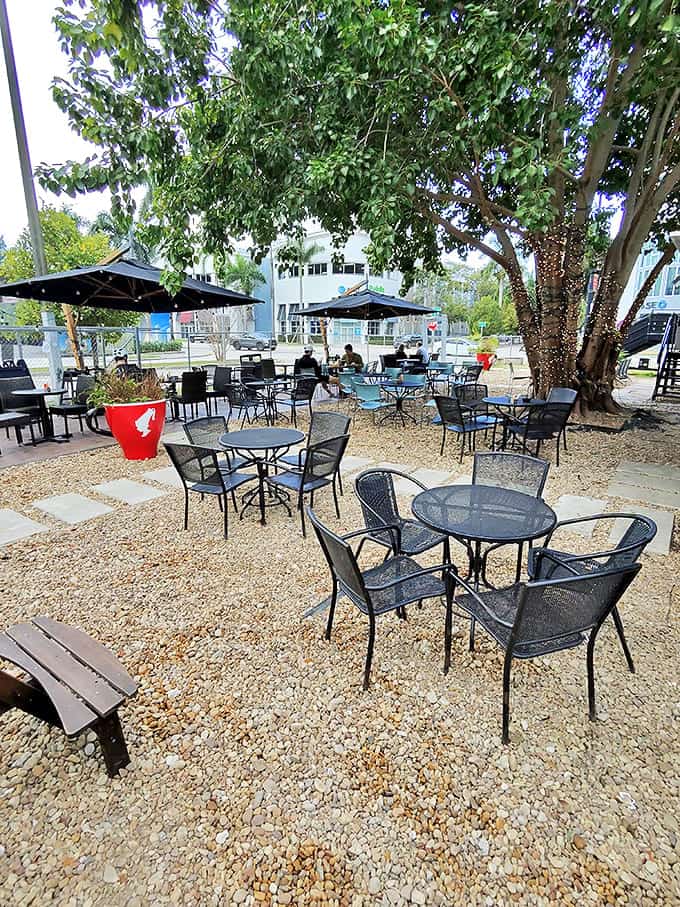 The outdoor seating area offers a tranquil respite under shade trees, where the gentle Miami breeze complements your caffeine fix perfectly.