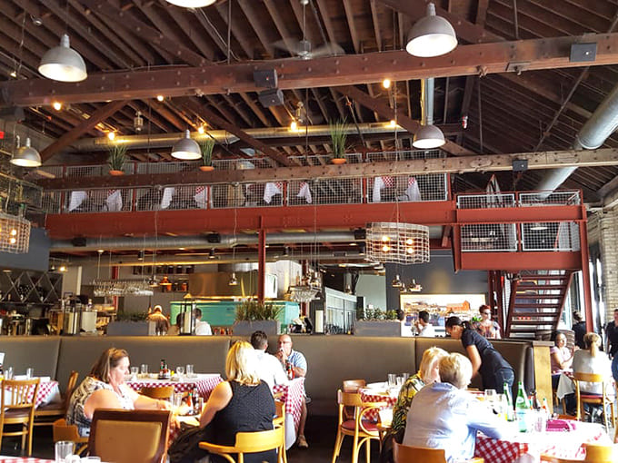 The mezzanine level overlooks the bustling dining room below, where the energy is always high and the food even higher quality.