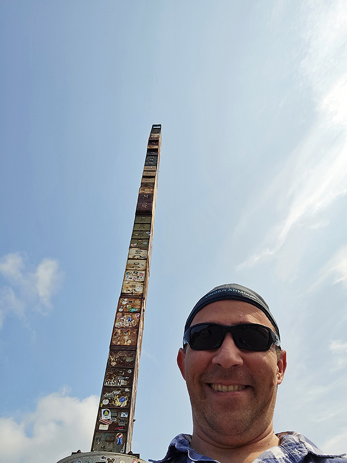 A visitor captures the perfect selfie with Burlington's most unusual celebrity – 38 feet of office furniture stacked toward the heavens.