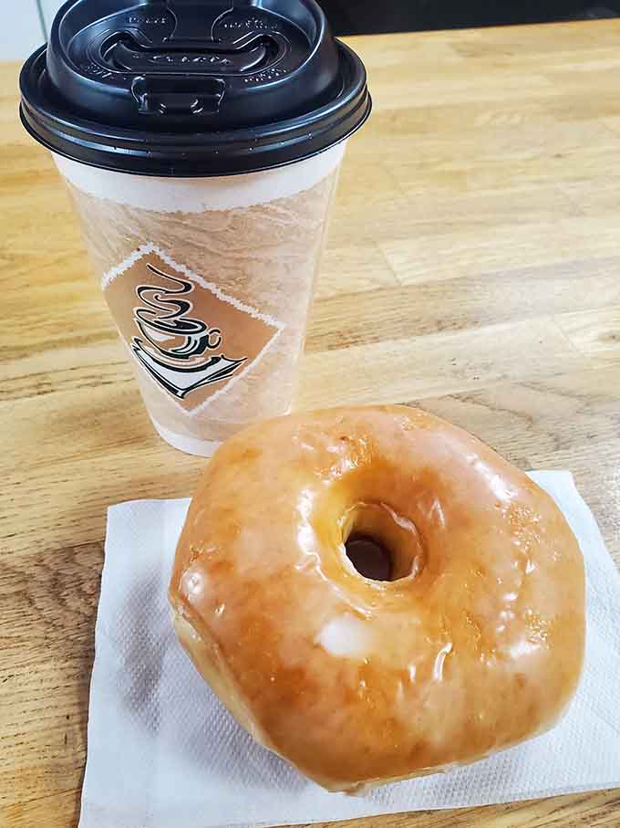 Fresh coffee and a glazed donut represent the perfect morning combination that's been making people happy since forever.