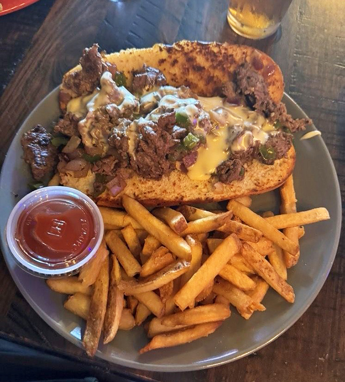 The steak and cheese sub comes piled high with savory meat and melted cheese, proving that sometimes the simplest combinations make the most satisfying meals.