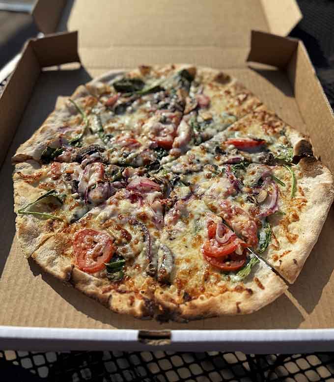 Wood-fired pizza fresh from the oven, loaded with toppings and ready to fuel your North Shore adventures or just your afternoon on the deck.