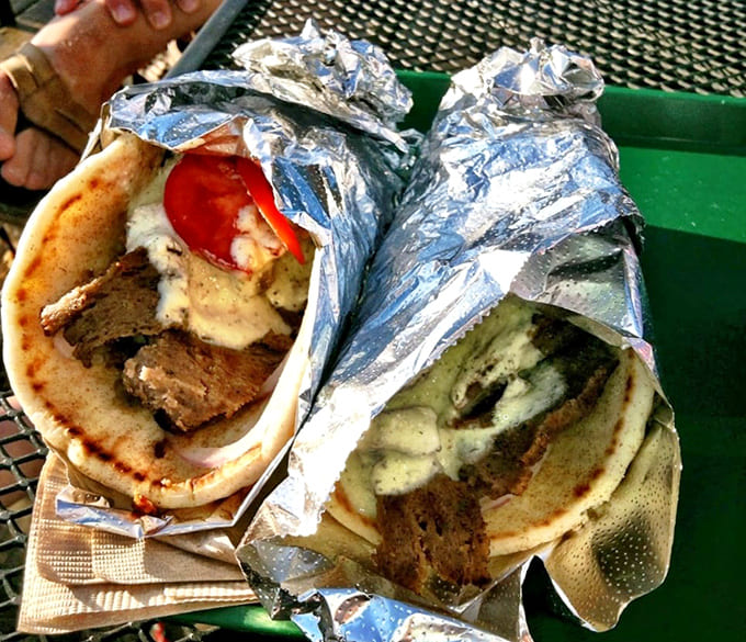 Gyros wrapped in foil like delicious presents, stuffed with properly seasoned meat and fresh vegetables that'll make you rethink every mediocre gyro you've ever tolerated.