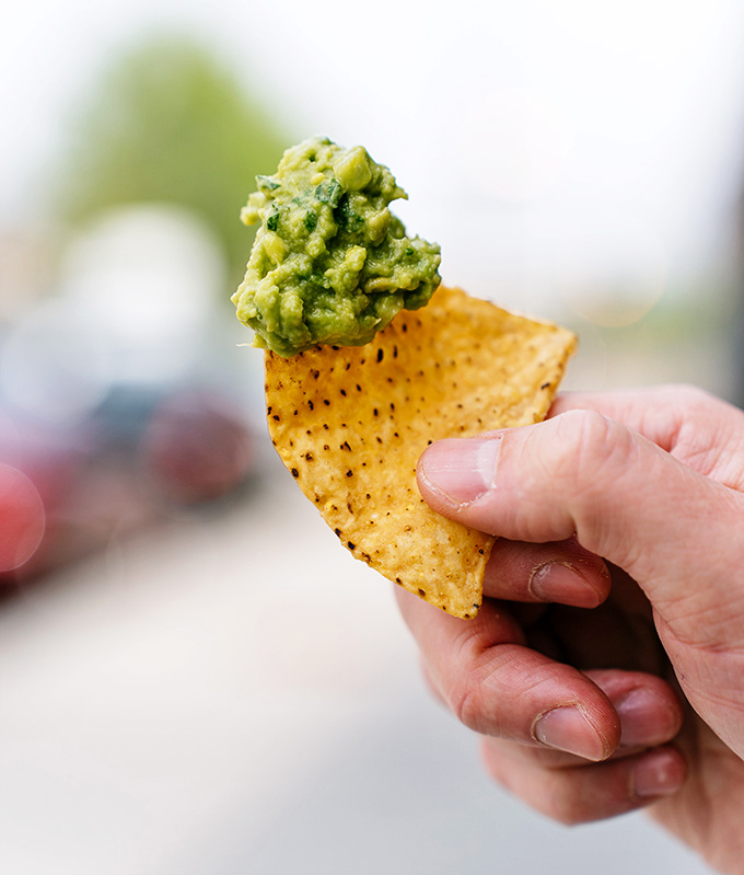 Fresh guacamole on a crispy chip, the perfect opening act before the main event arrives.