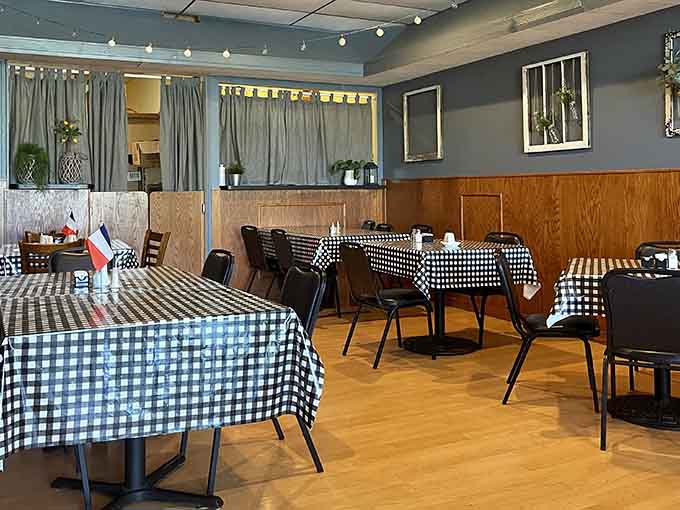 Those black and white checkered tablecloths create a classic bistro vibe that's both charming and unpretentious.