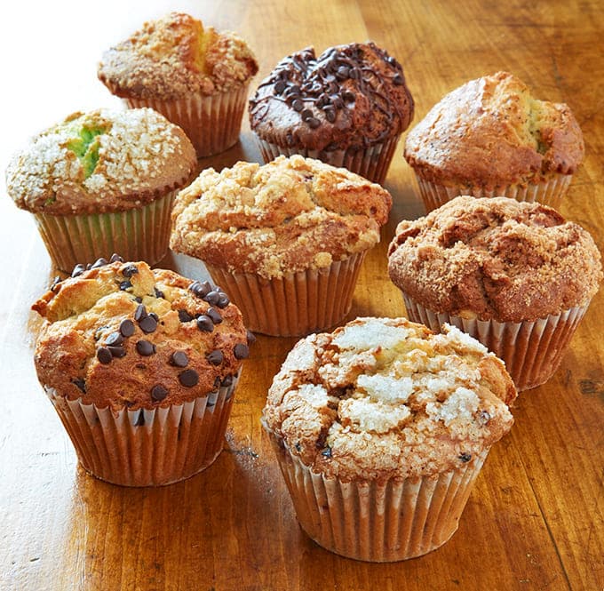 Muffins with proper dome tops and visible mix-ins, looking exactly like muffins should before the world got confused about them.