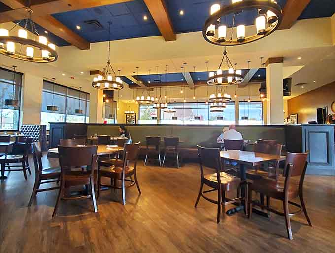 Spacious dining areas with natural light prove that sports bars can be attractive and comfortable simultaneously.