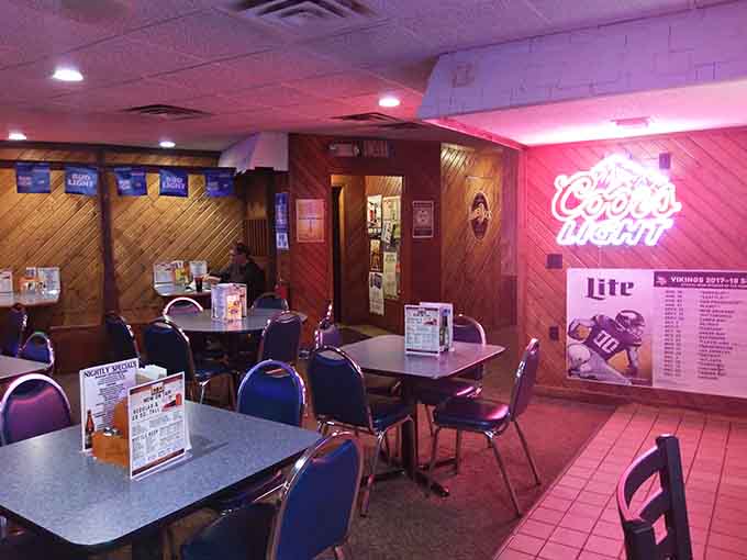The dining area glows with neon beer signs and comfortable seating where locals gather for good food and better company.