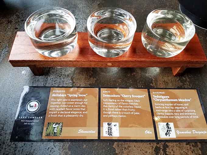 The sake sampler presents three distinct personalities in tiny glasses, each one telling its own story about Japanese brewing traditions and craftsmanship.