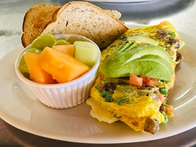 Veggie Omelet: This egg envelope delivers a garden-fresh package alongside buttery avocado slices and fruit that tastes like it was picked this morning.