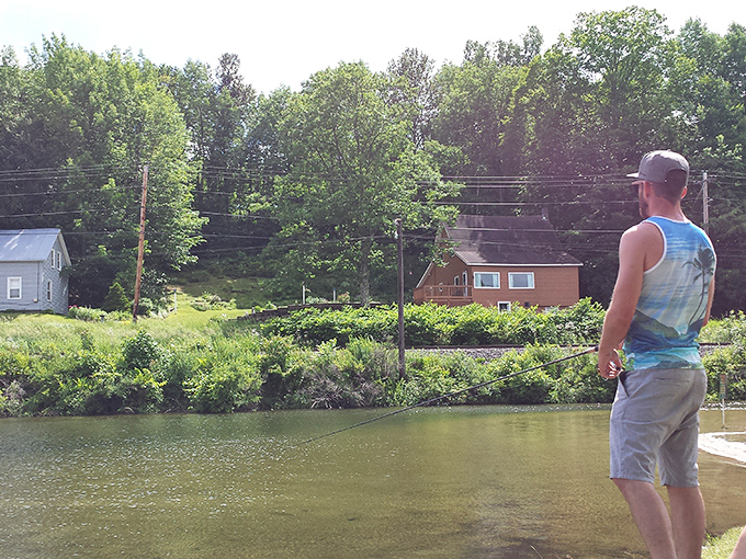The patient fisherman waits, demonstrating that sometimes the best vacation activity is simply standing still in beautiful surroundings.