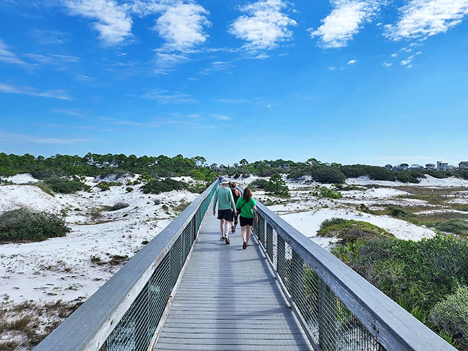 Fellow adventurers traverse the elevated boardwalk, their silhouettes dwarfed by the magnificent natural landscape.