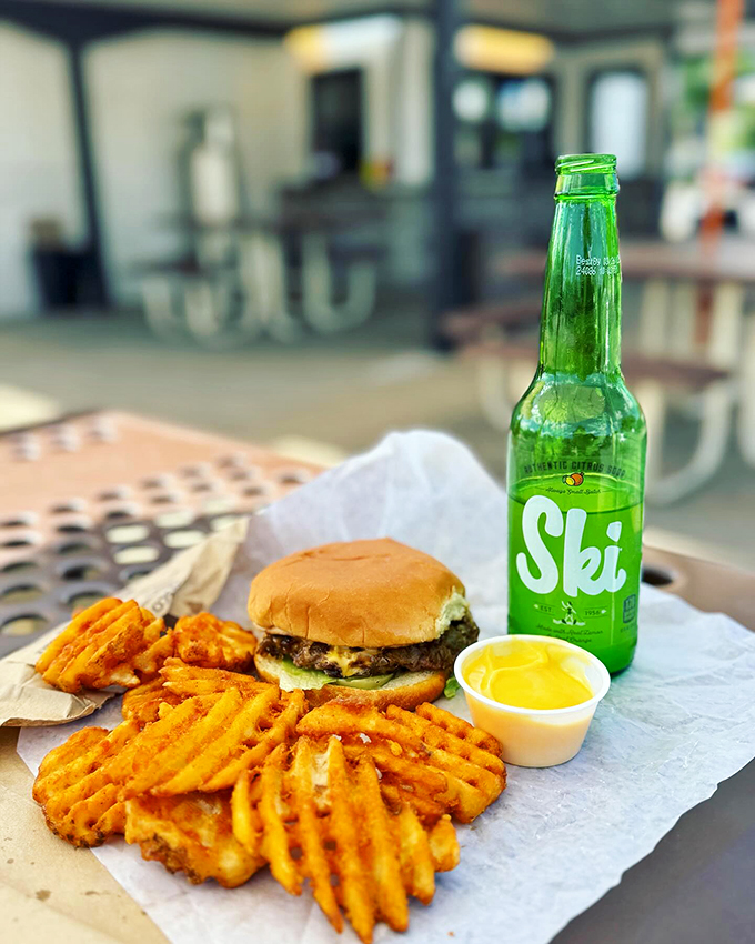 The ultimate Wally's trifecta: a juicy cheeseburger, crispy waffle fries, and refreshing Ski soda. It's like a party for your mouth!