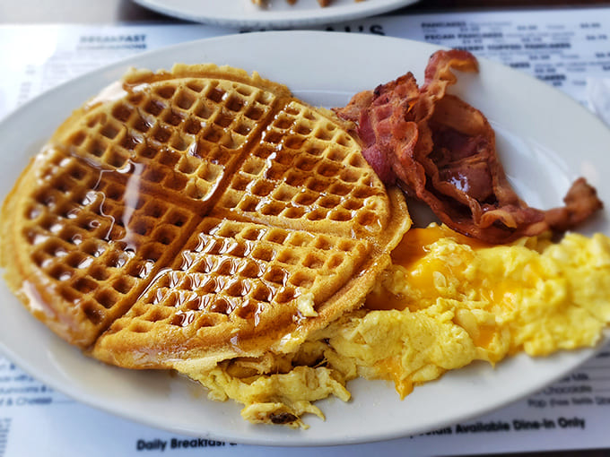 Waffle perfection with crisp edges and tender centers, flanked by bacon and eggs &ndash; the breakfast trifecta that's worth getting out of bed for.