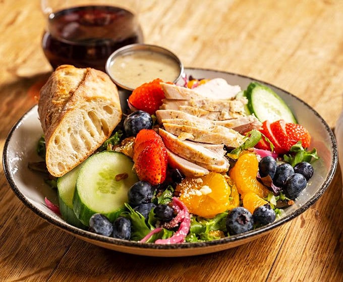 This vibrant salad proves healthy eating needn't be boring &ndash; fresh berries, grilled chicken, and crisp vegetables create a rainbow of flavors.