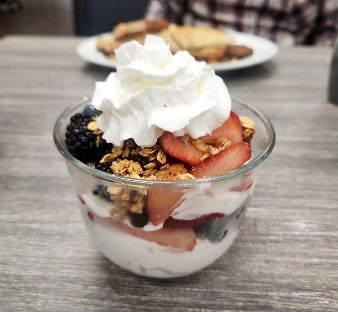 Layers of yogurt, fresh berries, and house-made granola create a breakfast parfait that doesn't feel like punishment for skipping the pancakes.