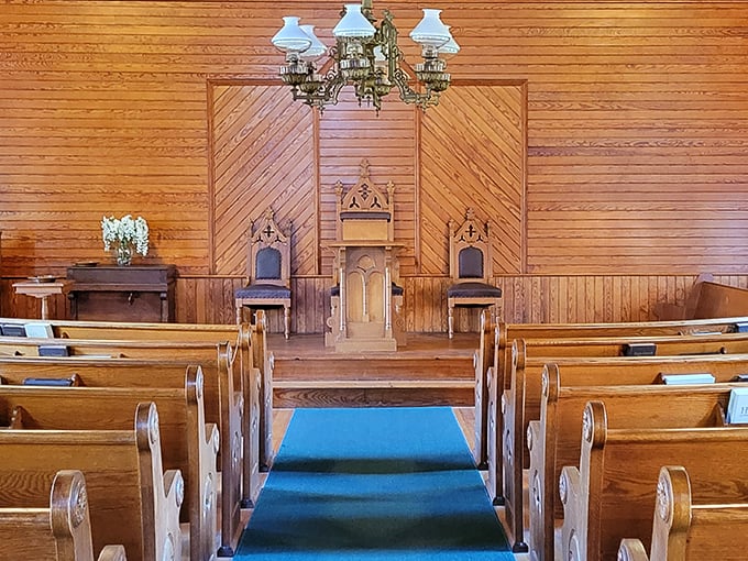 Simple wooden pews and warm paneling create a sanctuary where even the most restless soul might find a moment of quiet reflection.