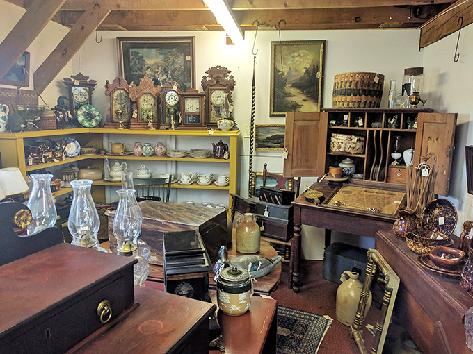 Antique clocks, oil lamps, and china create a time capsule display, each piece whispering stories of dinner parties and family gatherings from decades past.