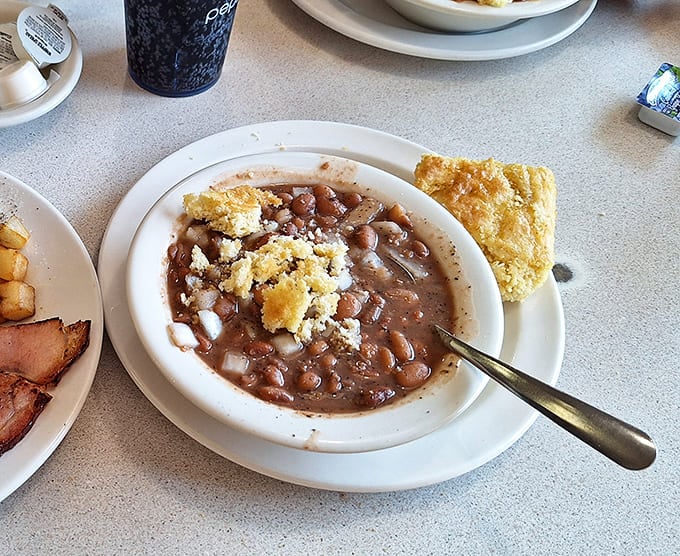 A bowl of beans with ham hocks that's been simmering since yesterday, developing the kind of flavor that can't be rushed.