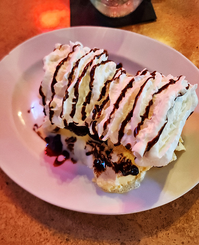 A mountain of whipped cream cascades down a brownie sundae &ndash; the perfect sweet finale to a meal that celebrates American classics.