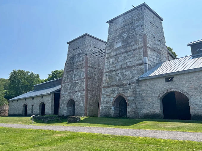 Towering limestone kilns reach skyward like industrial cathedrals, their massive scale hinting at the intense heat and activity they once contained.