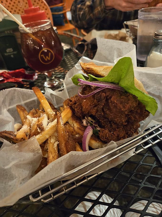 The buttermilk fried chicken sandwich arrives with crispy perfection, proving Worthy Burger's mastery extends well beyond their namesake beef offerings.