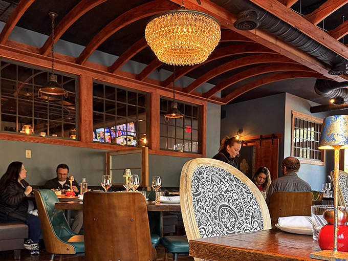 Elegant yet comfortable seating invites conversation and lingering, while crystal chandeliers cast a warm glow over happy diners.