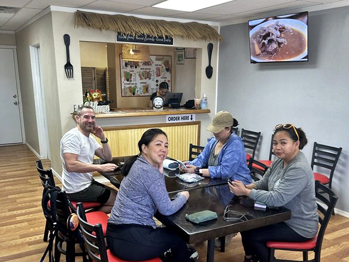 Happy diners gathered around the table, proving that good food brings people together. The smiles say it all!