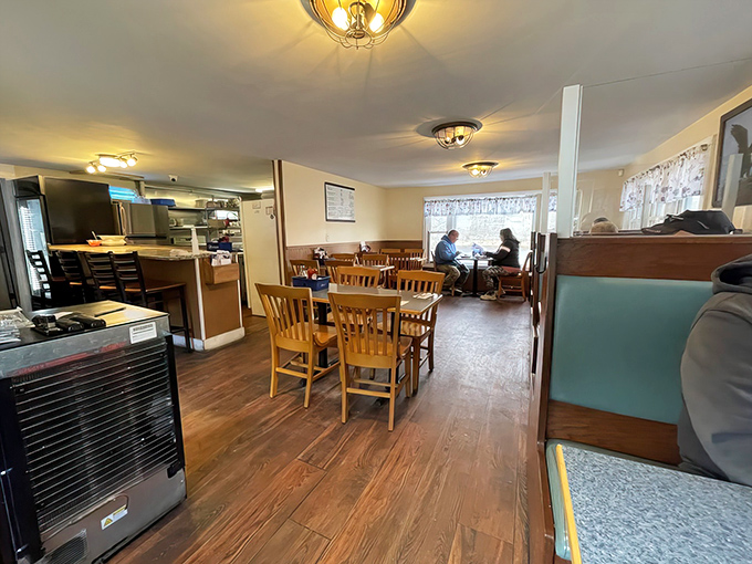 The dining room's warm wood paneling and simple furnishings create a cozy atmosphere for enjoying Maine's bounty.