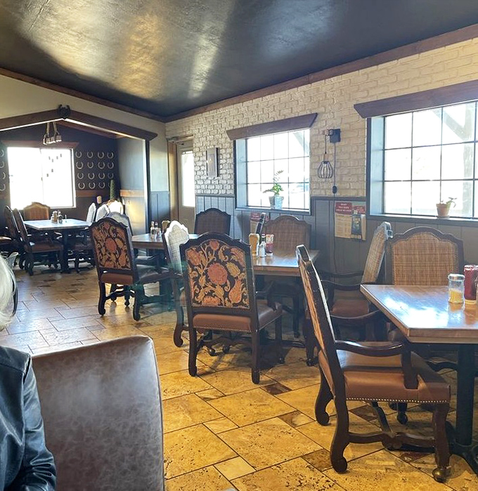 The dining area strikes that perfect balance between spacious and cozy, with brick walls and wooden accents creating a timeless, welcoming atmosphere.