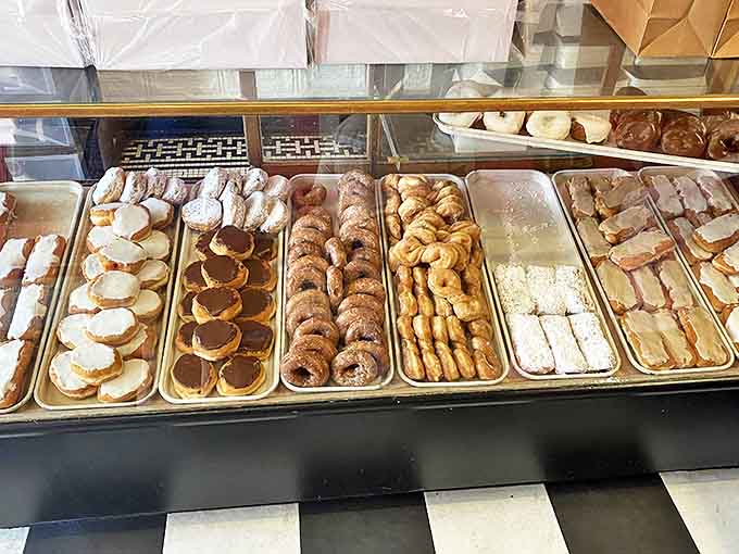 Trays of handcrafted pastries line the display case, each representing decades of perfected recipes and techniques that modern bakeries try desperately to recreate.
