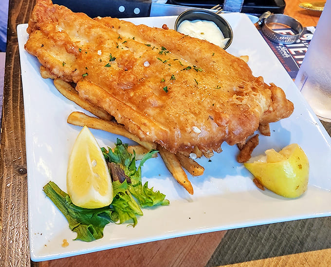 Golden-battered fish that shatters with each bite, served alongside fries that could make a Frenchman weep with joy.