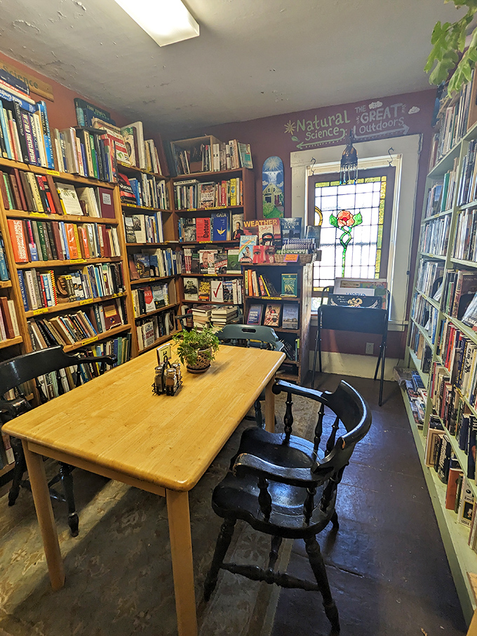A study in literary coziness: warm lighting, wooden tables, and walls of books create the perfect environment for losing track of time.