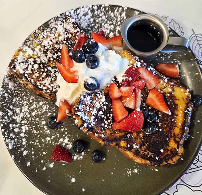 French toast topped with fresh berries and powdered sugar looks almost too beautiful to eat, but you'll manage somehow.