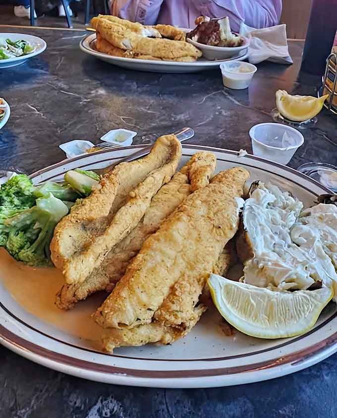 Perfectly fried fish fillets that flake at the touch of a fork – proof that simple food done right beats fancy cuisine any day.