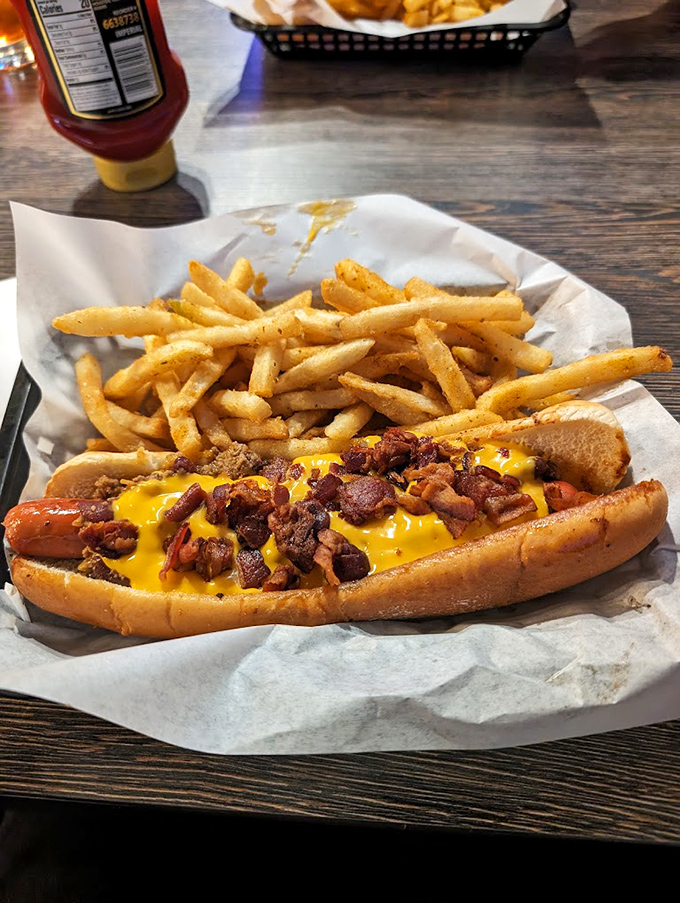 Not your ballpark frank! This beauty comes loaded with cheese and bacon &ndash; the kind of hot dog that demands to be eaten with two hands.