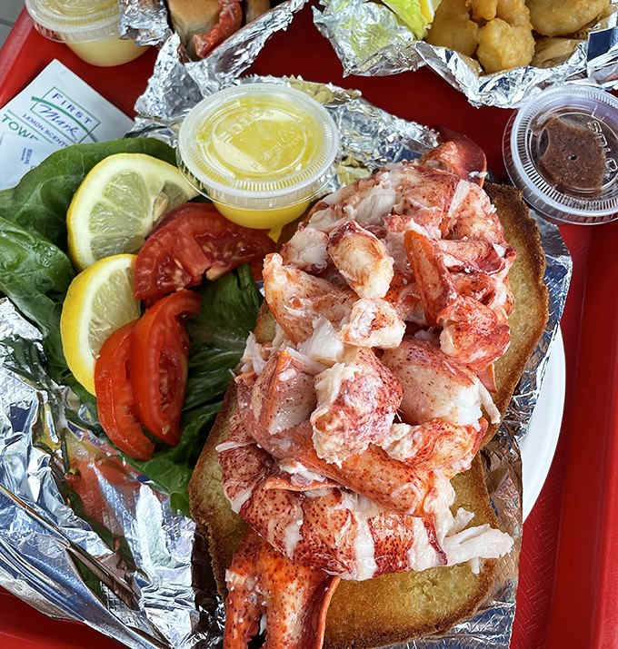 The legendary lobster roll – sweet chunks of Maine lobster meat piled high on a toasted bun, ready for a drizzle of butter.